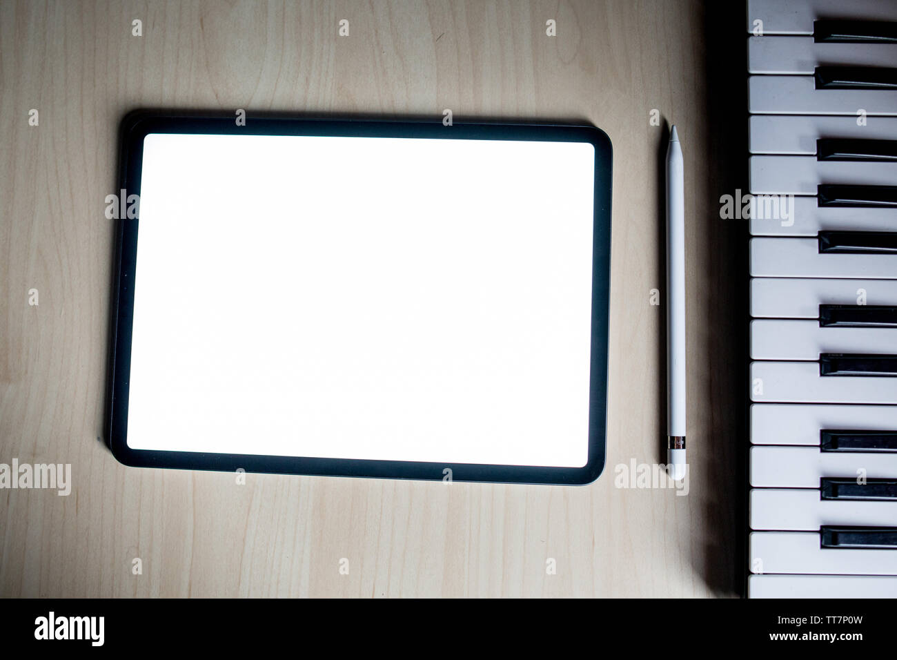 pro tablet for artist with pencil flat lay top view with midi keyboard ...