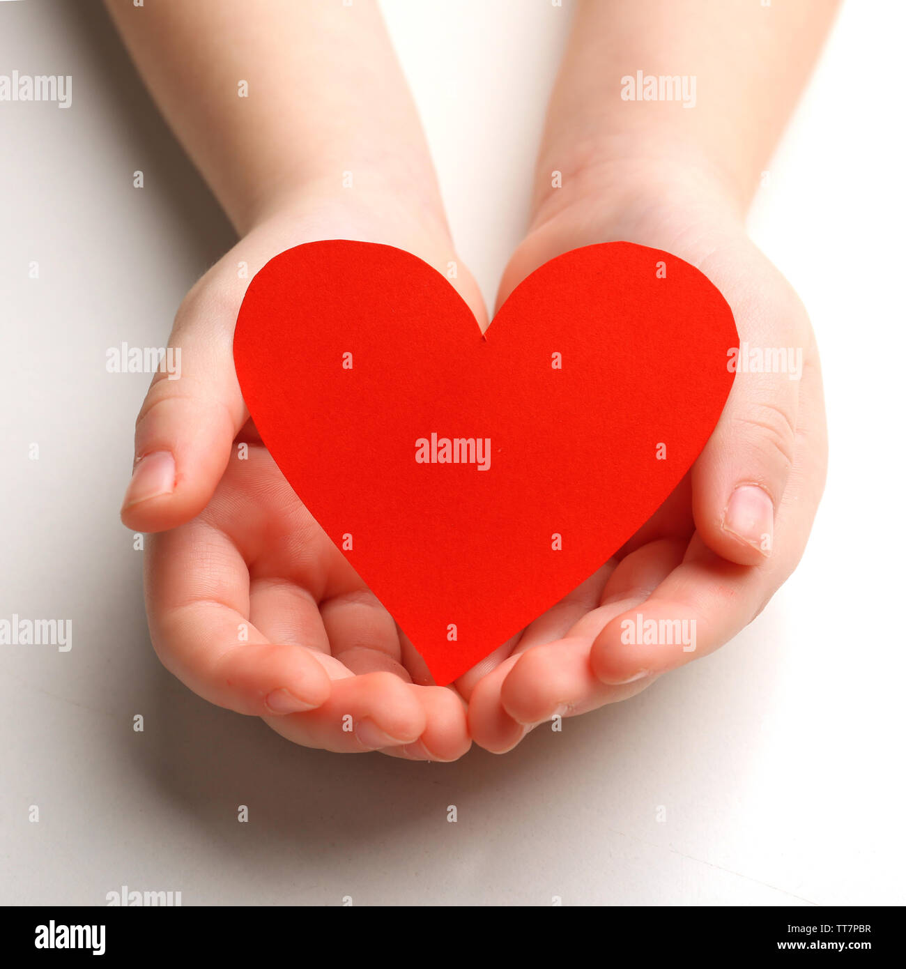 Heart in child hands isolated on white Stock Photo - Alamy