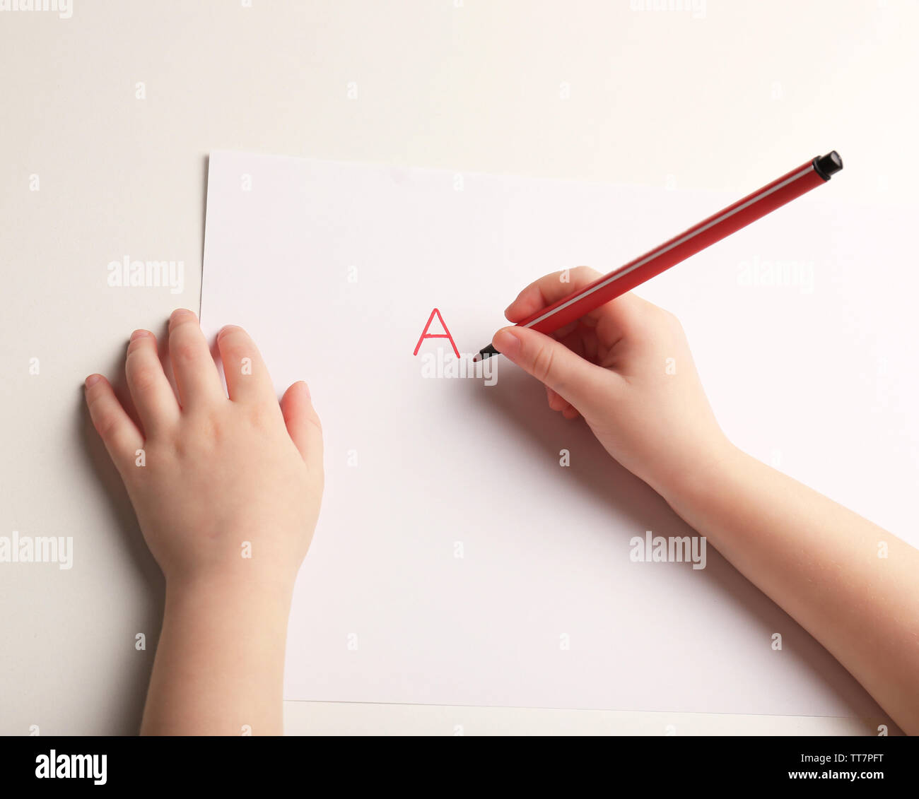 Child hand writing letters Stock Photo - Alamy