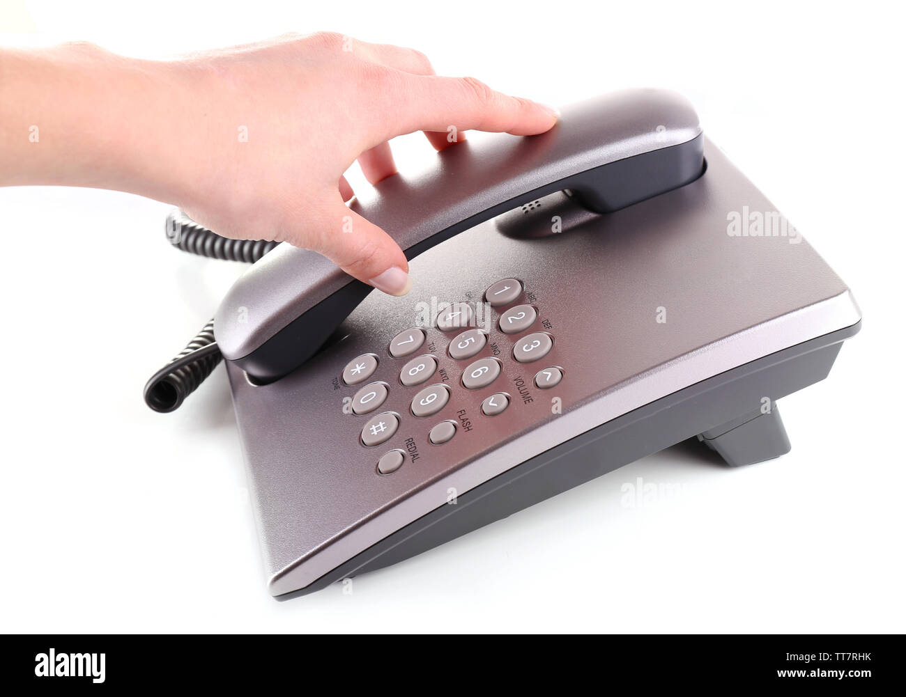 Female hand holding phone receiver isolated on white Stock Photo - Alamy