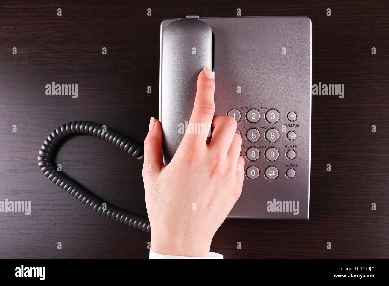 Female hand holding phone receiver isolated on white Stock Photo - Alamy