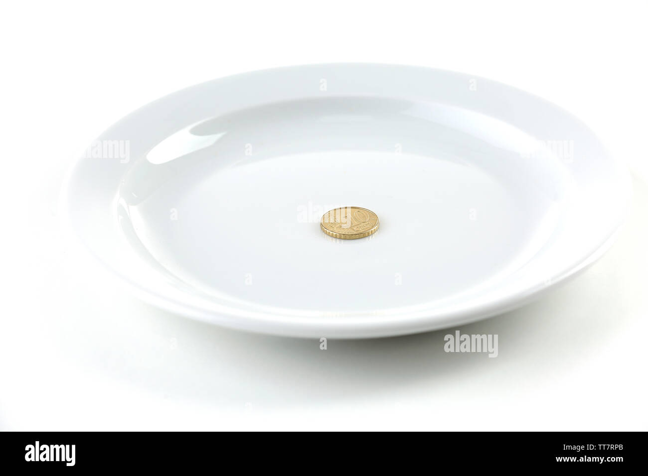 Coin on plate isolated on white Stock Photo - Alamy