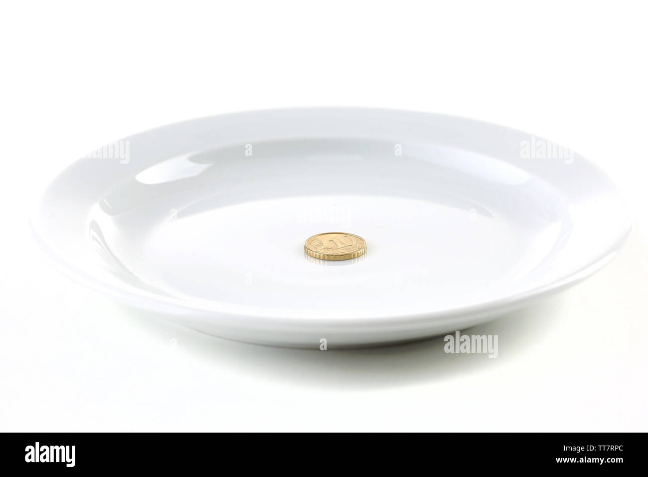 Coin on plate isolated on white Stock Photo - Alamy