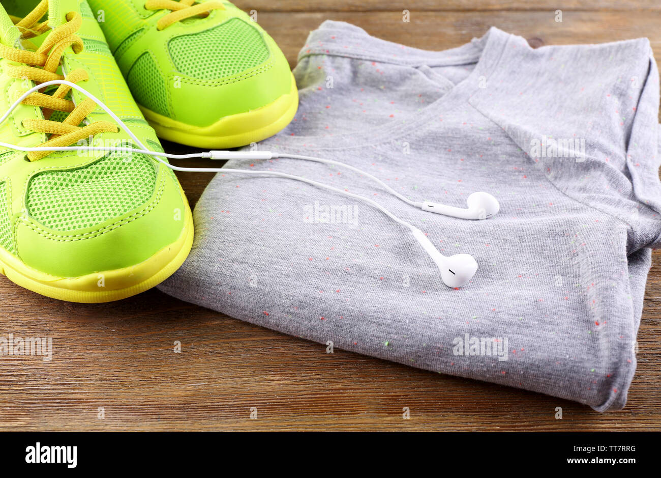 Sport shoes and clothes on wooden background Stock Photo - Alamy