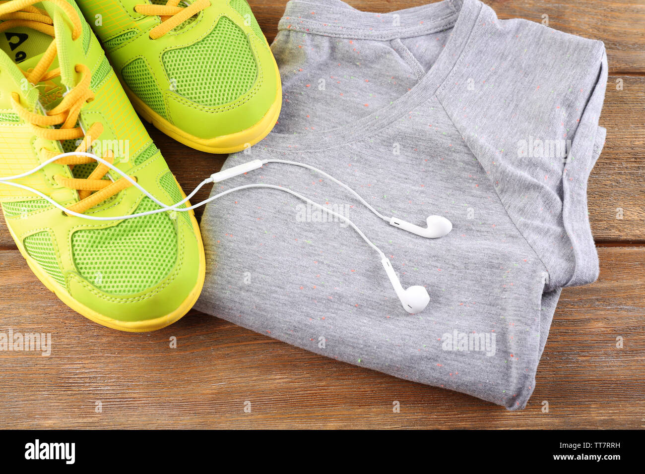Sport shoes and clothes on wooden background Stock Photo - Alamy