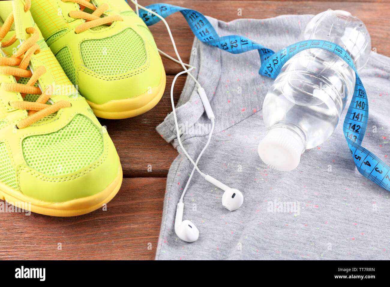 Sport shoes and clothes on wooden background Stock Photo - Alamy