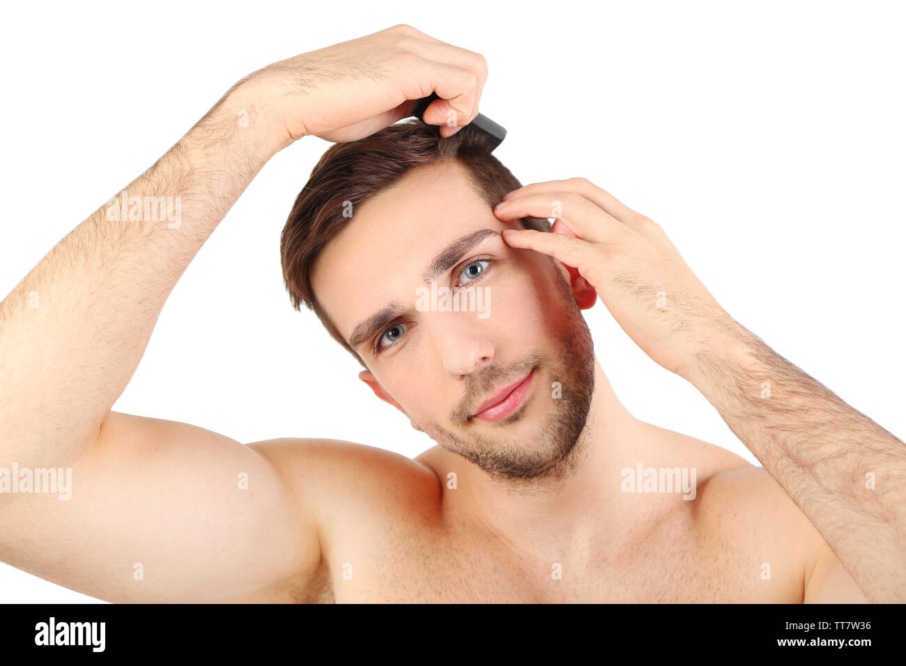 Handsome young man combing his hair isolated on white Stock Photo - Alamy