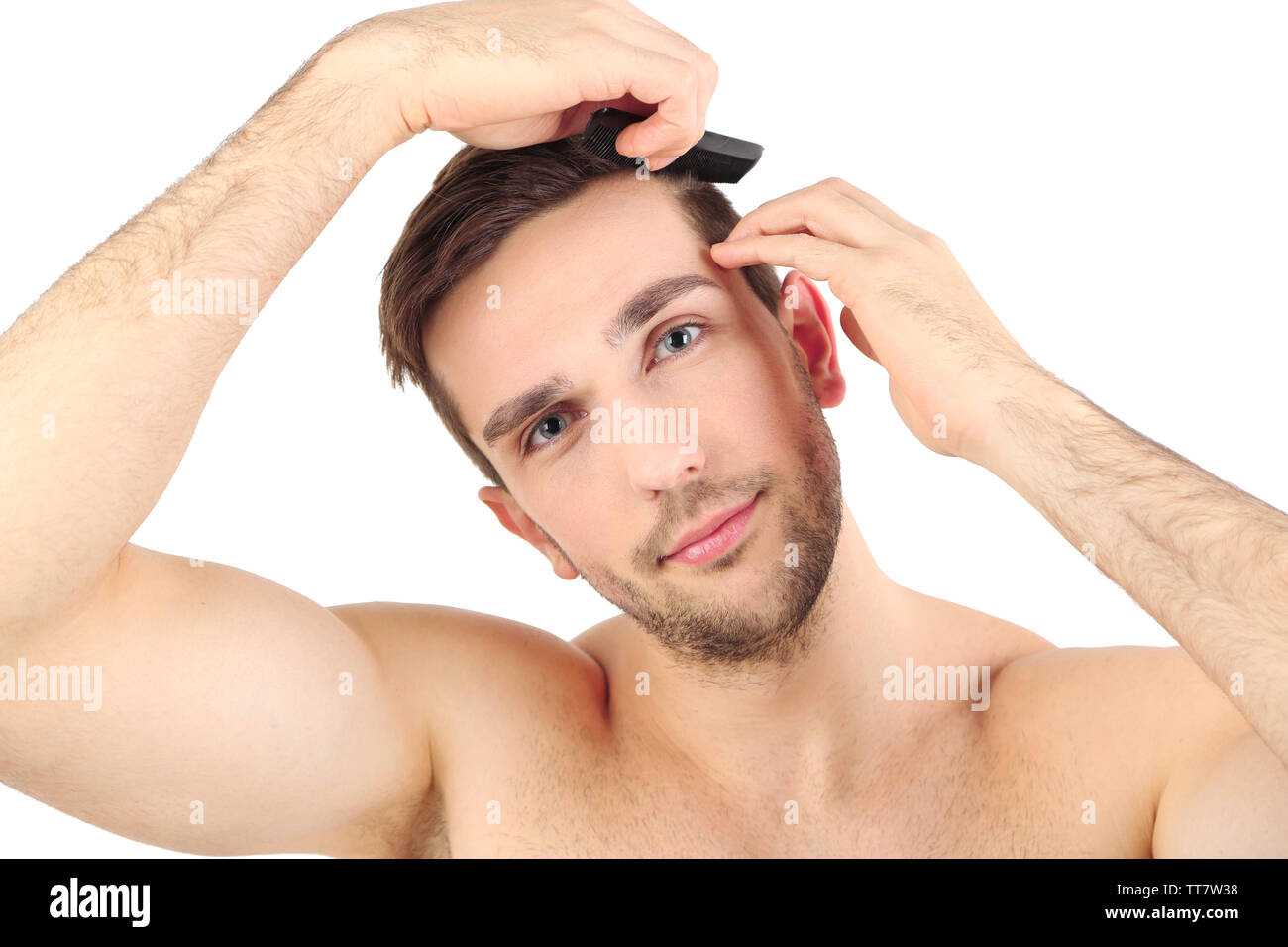 Handsome young man combing his hair isolated on white Stock Photo - Alamy
