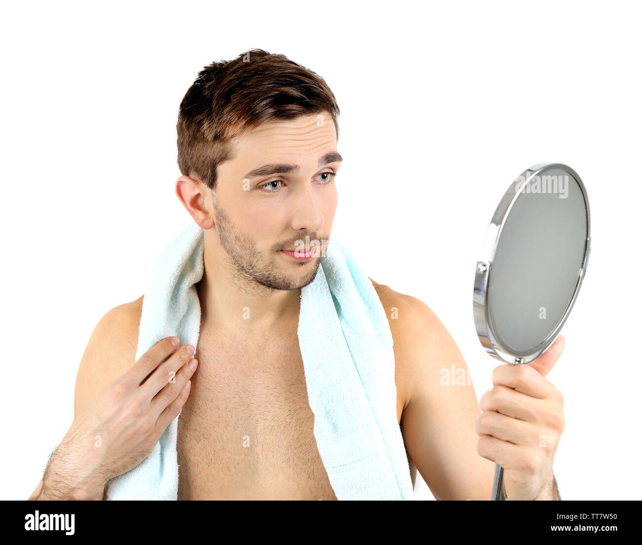 Handsome young man with towel holding mirror isolated on white Stock ...