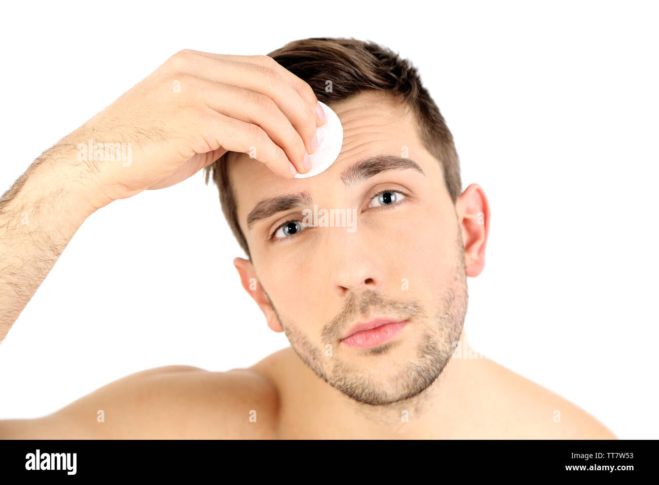 Handsome young man cleansing face isolated on white Stock Photo - Alamy