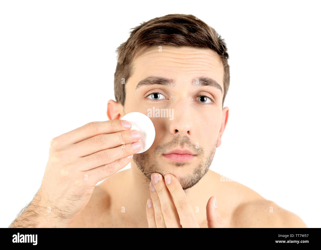 Handsome young man cleansing face isolated on white Stock Photo - Alamy