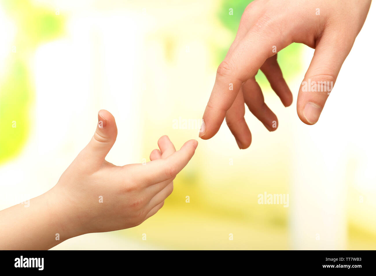 Child and father hands on bright background Stock Photo - Alamy