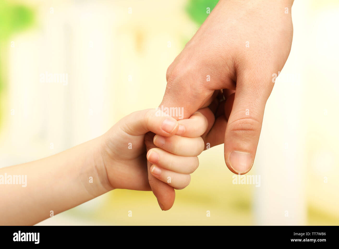 Child and father hands on bright background Stock Photo - Alamy