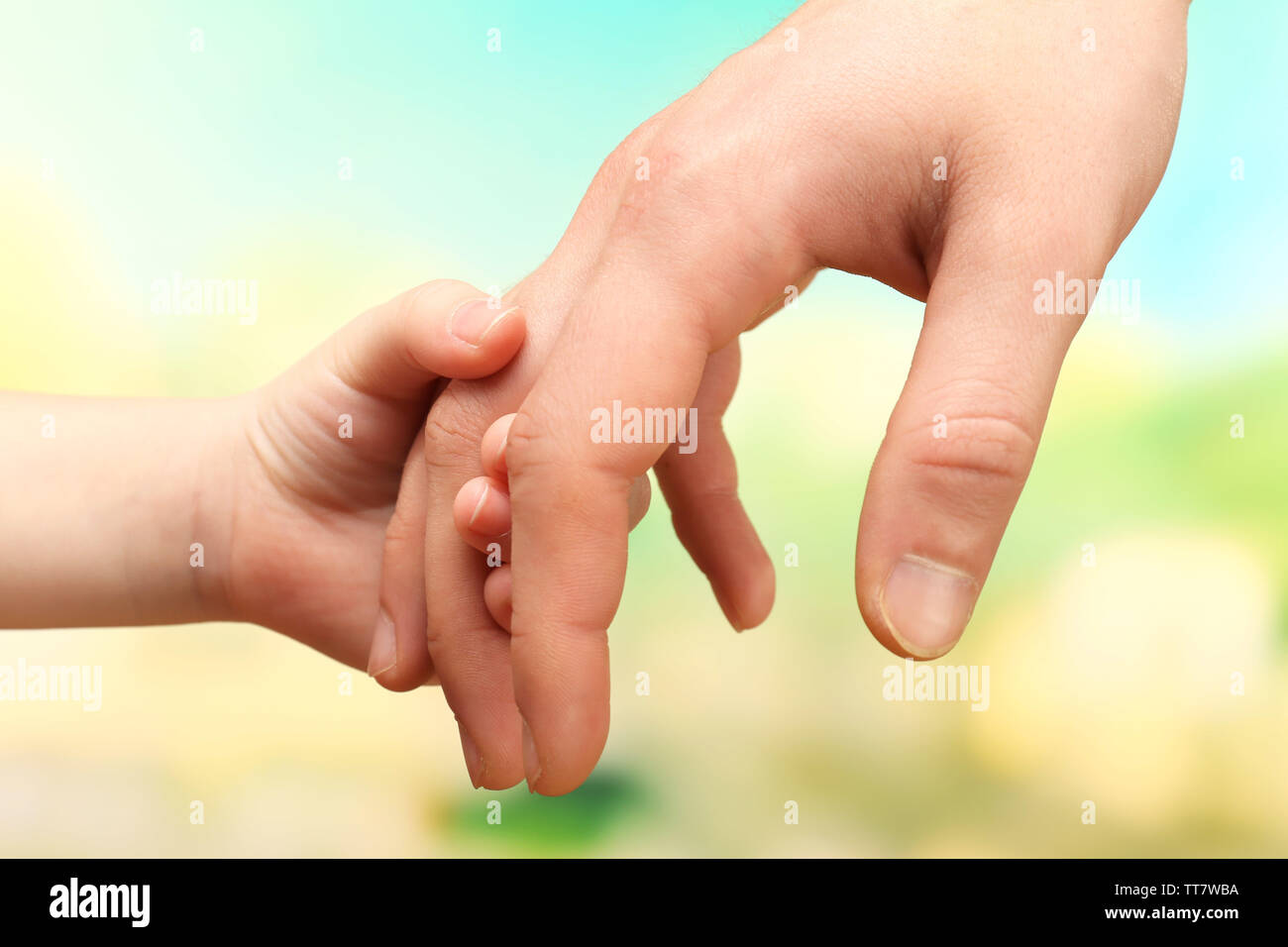 Child and father hands on bright background Stock Photo - Alamy