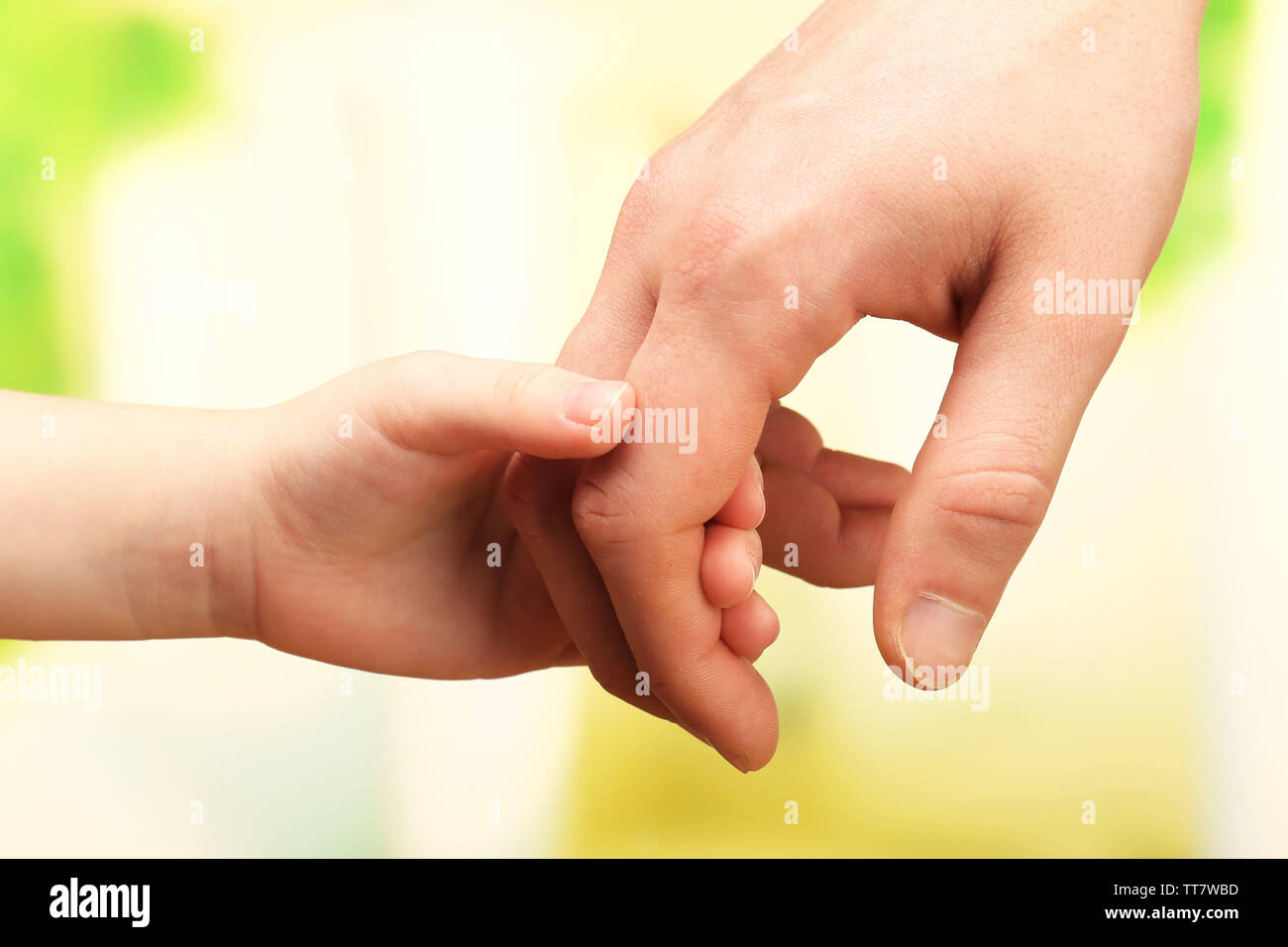 Child and father hands on bright background Stock Photo - Alamy