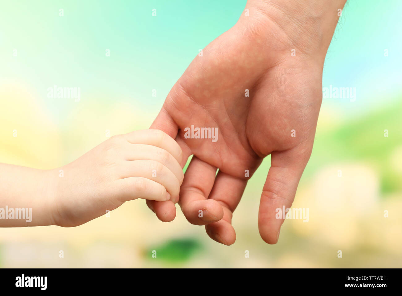 Child and father hands on bright background Stock Photo - Alamy