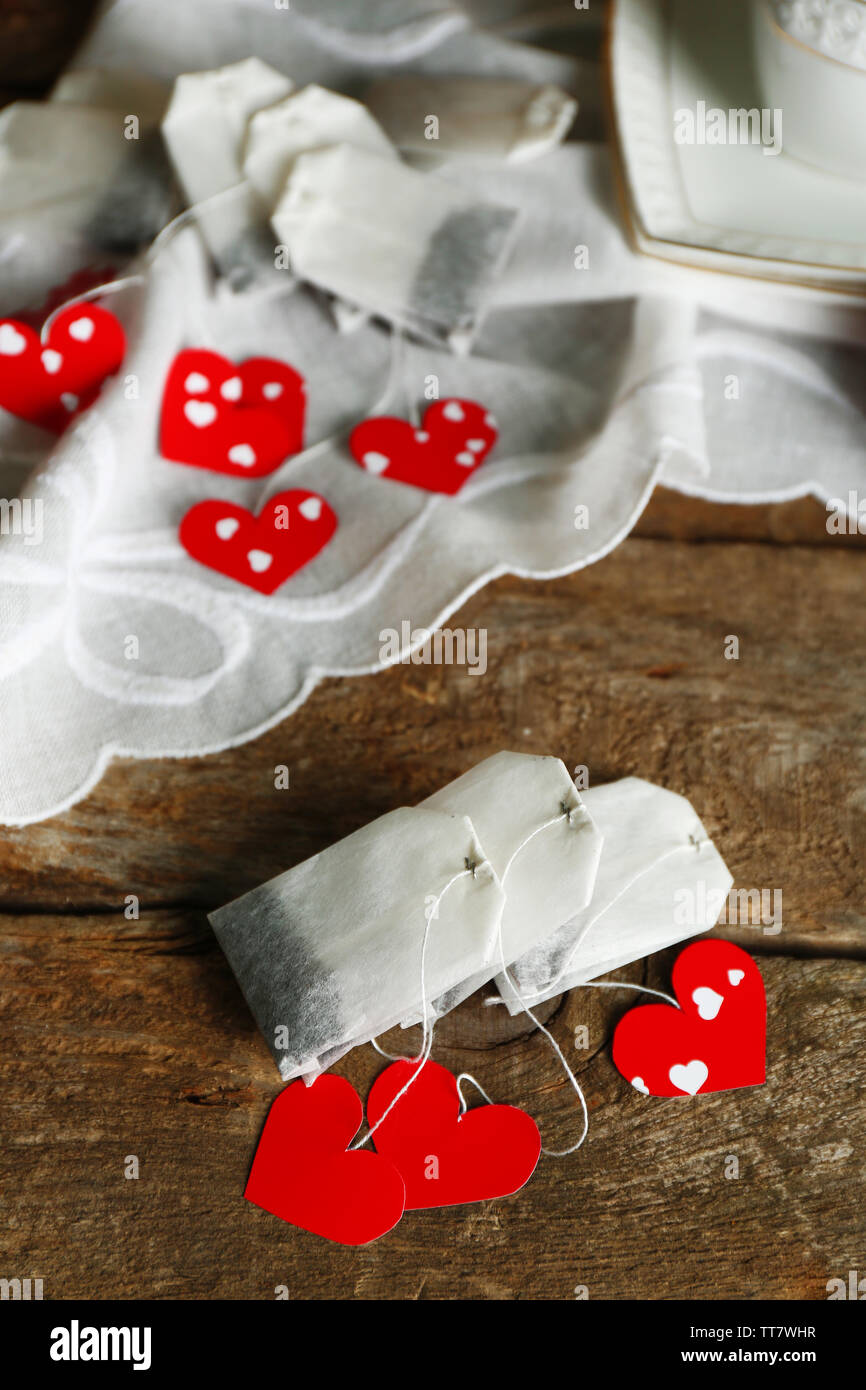 Heart shaped teabag tags and Cup of tea with on wooden background Stock ...