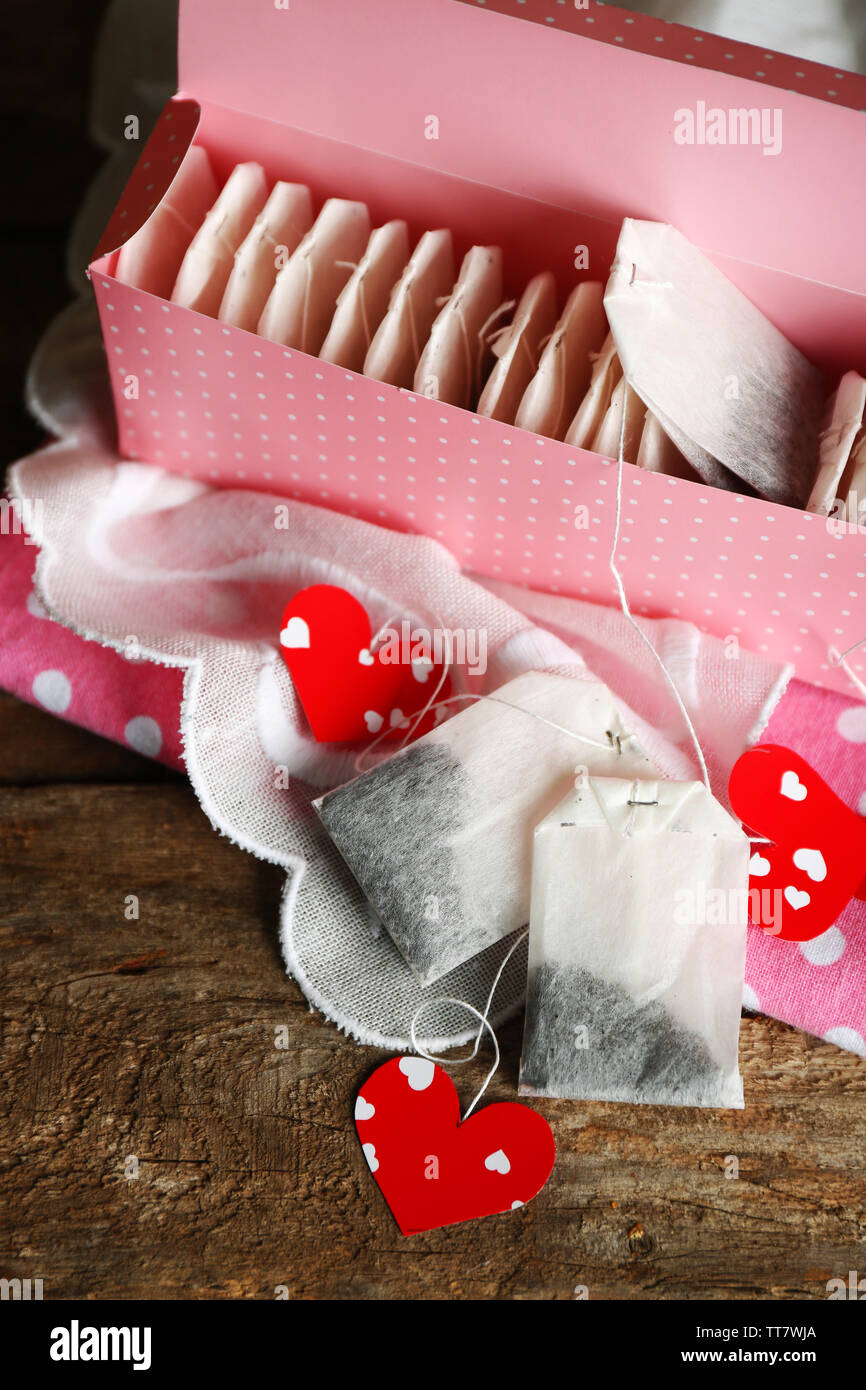 Heart shaped teabag tags and box on wooden background Stock Photo - Alamy