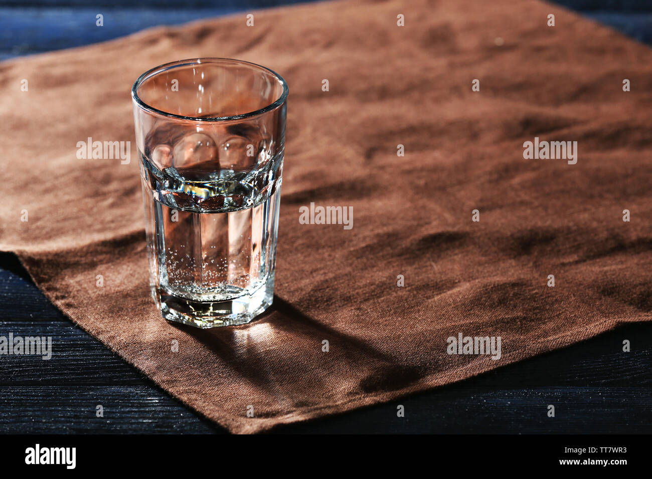 Glass of water on napkin close up Stock Photo - Alamy
