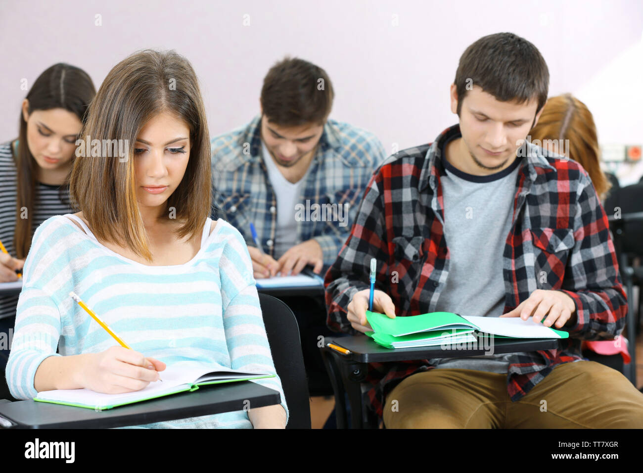 Group of students sitting in classroom Stock Photo - Alamy