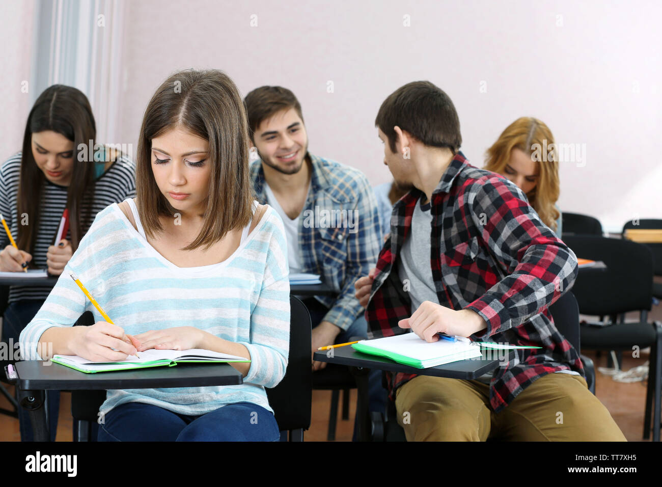 Group of students sitting in classroom Stock Photo - Alamy