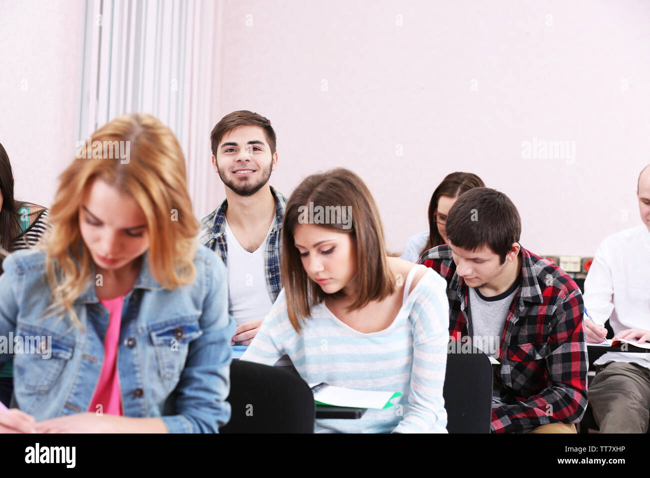 Group of students sitting in classroom Stock Photo - Alamy