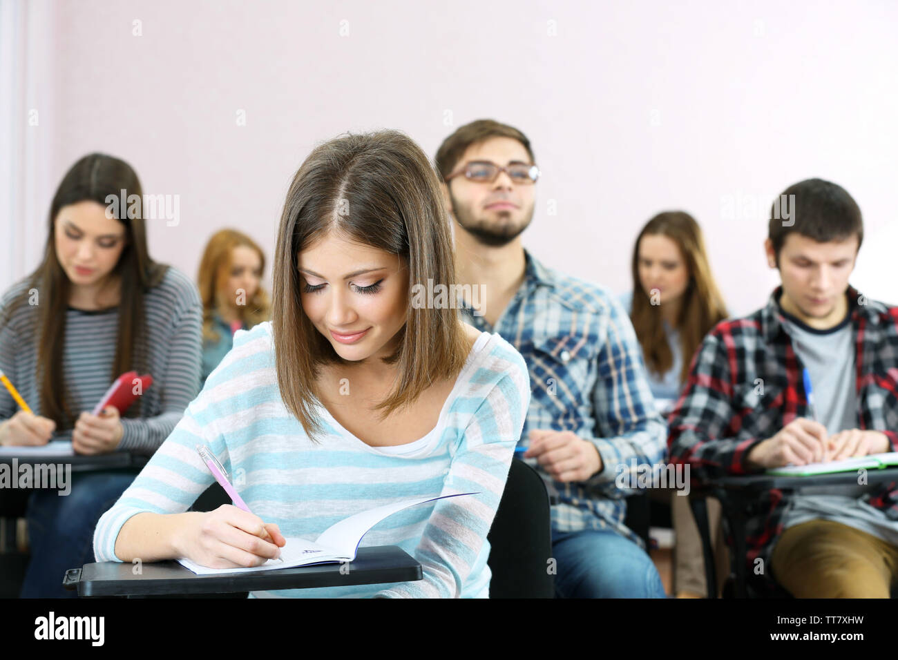 Group of students sitting in classroom Stock Photo - Alamy