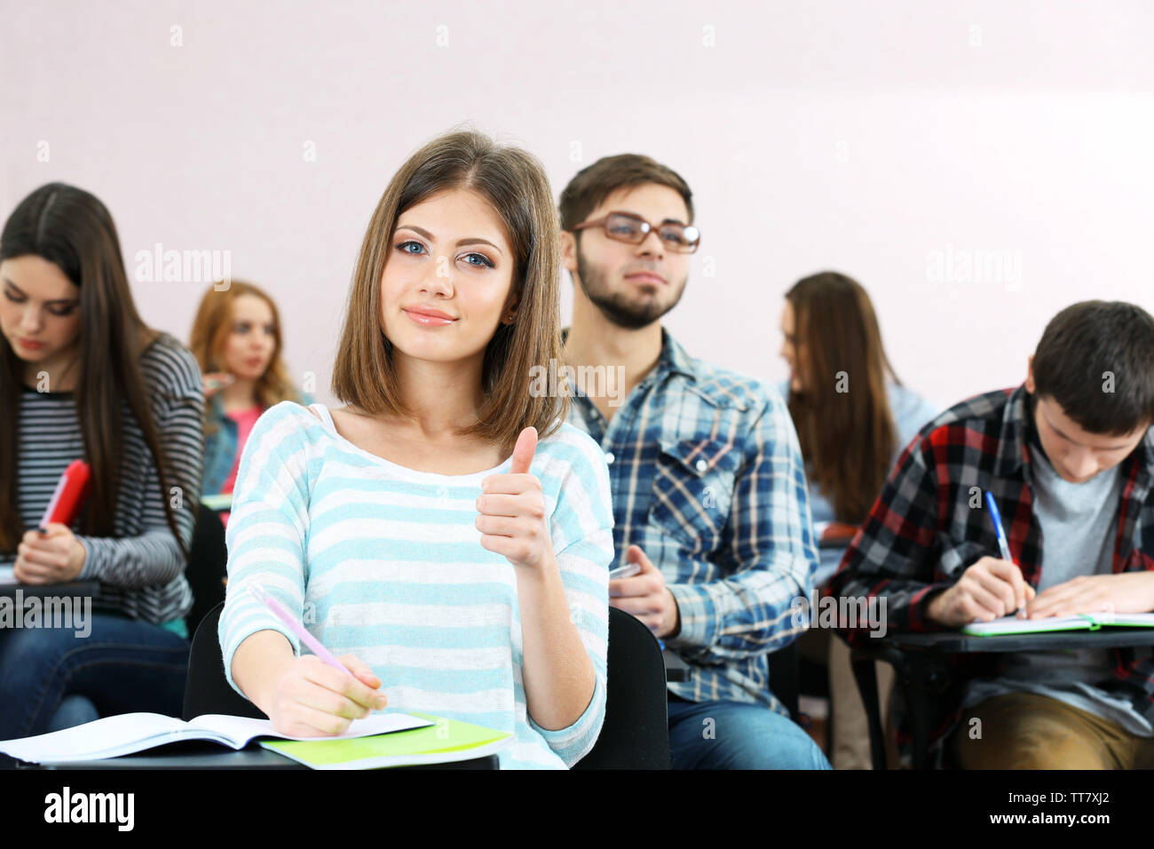 Group of students sitting in classroom Stock Photo - Alamy
