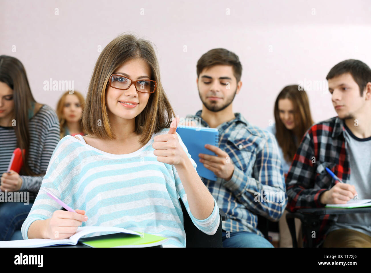 Group of students sitting in classroom Stock Photo - Alamy