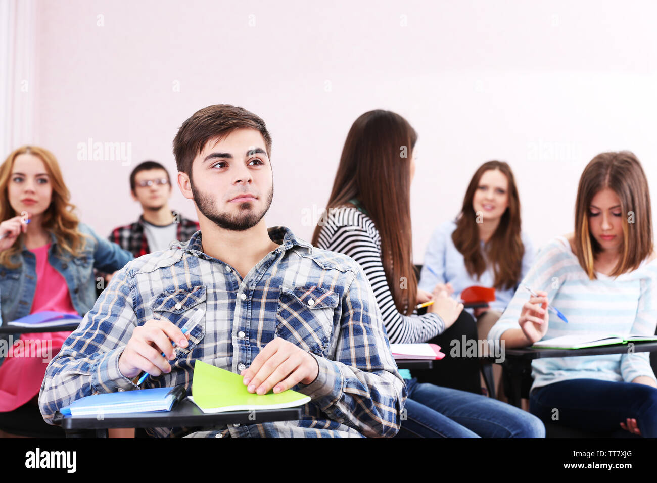 Group of students sitting in classroom Stock Photo - Alamy