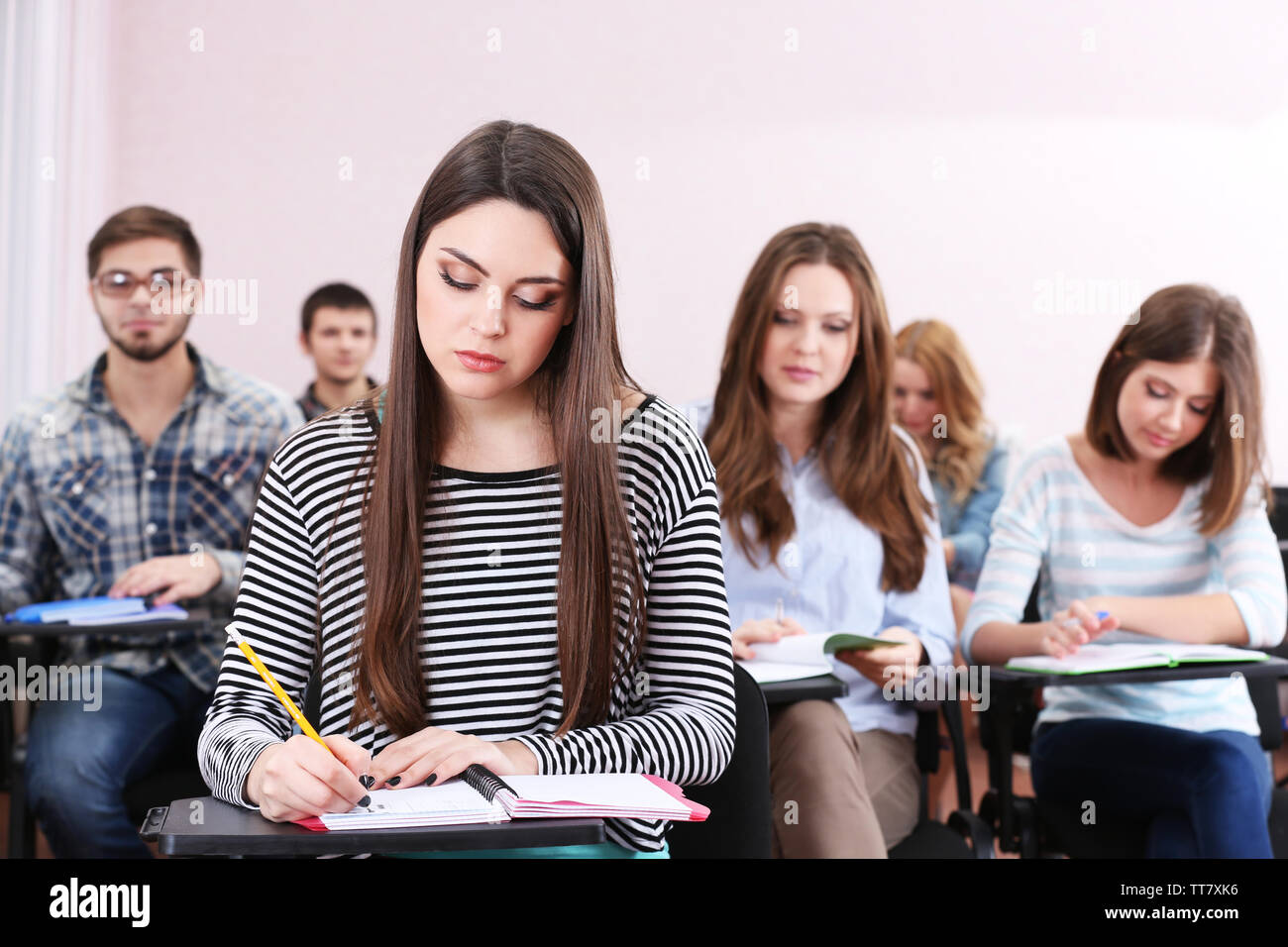 Group of students sitting in classroom Stock Photo - Alamy
