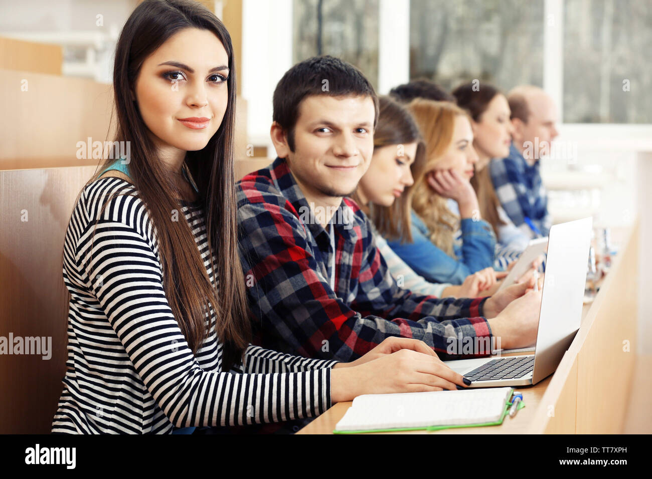 Group of students using gadgets in classroom Stock Photo - Alamy