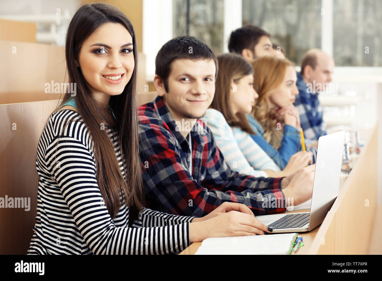 Group of students using gadgets in classroom Stock Photo - Alamy
