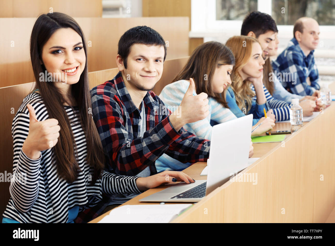 Group of students using gadgets in classroom Stock Photo - Alamy