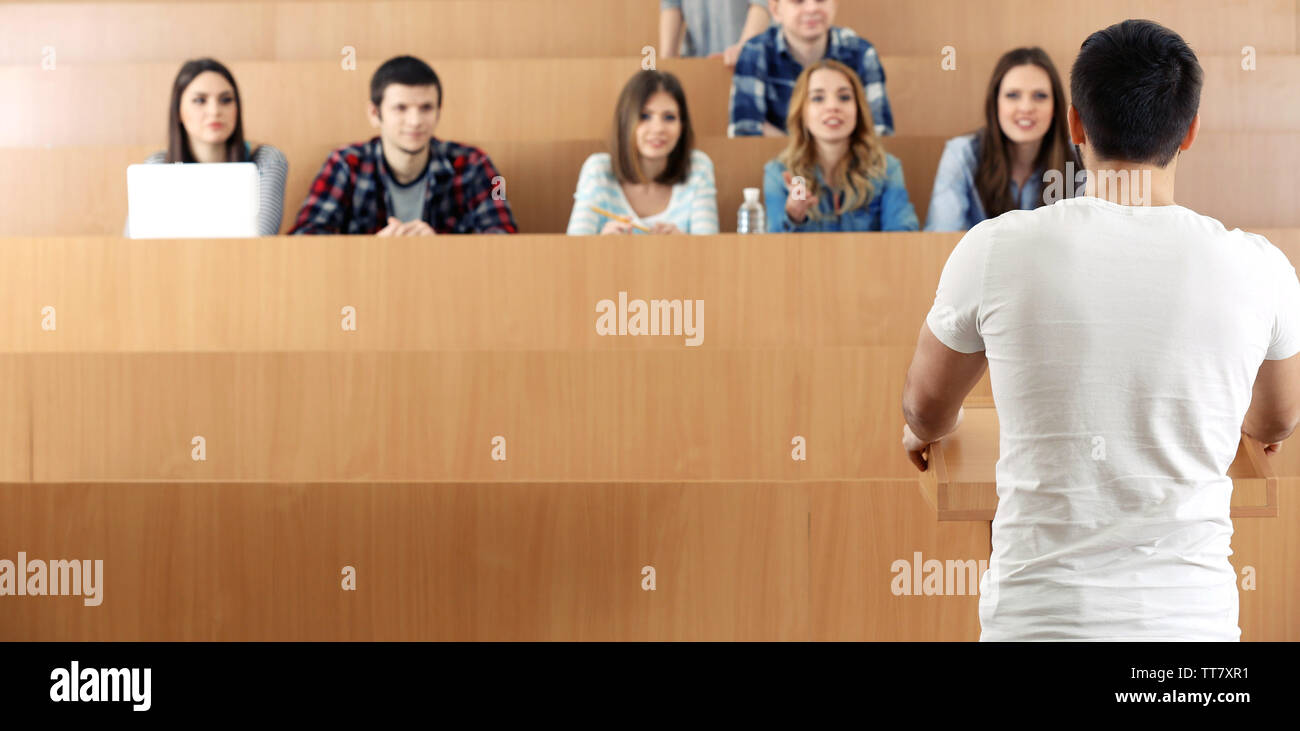 Group of students sitting in classroom and listening speaker Stock ...