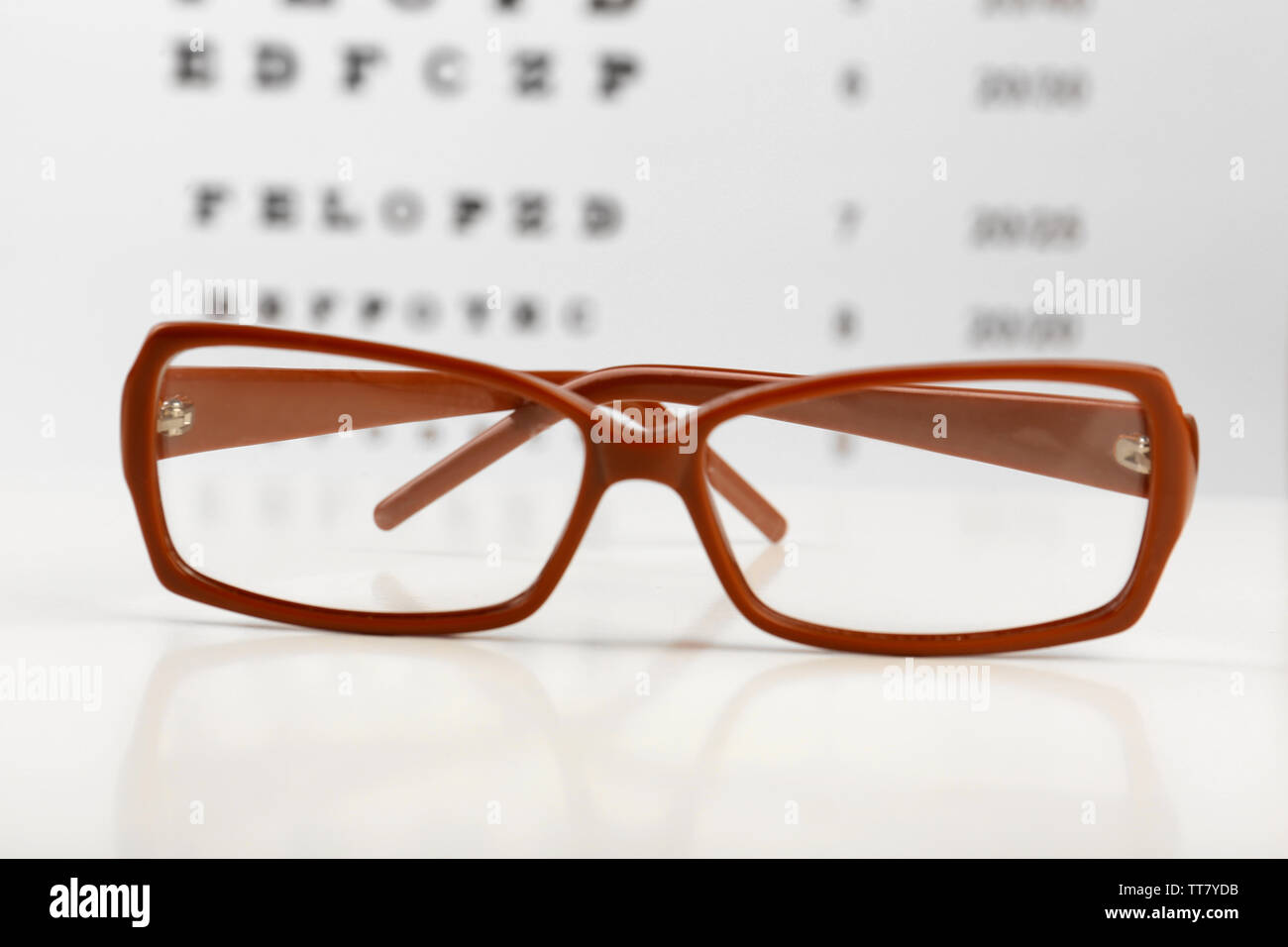 Glasses on eye chart background, close-up Stock Photo - Alamy