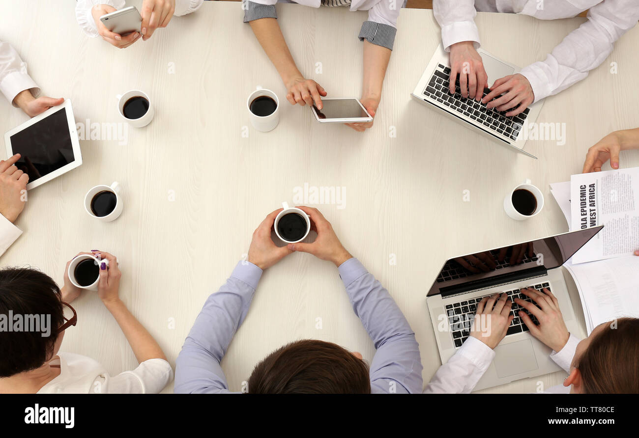 Group of business people working at desk top view Stock Photo - Alamy