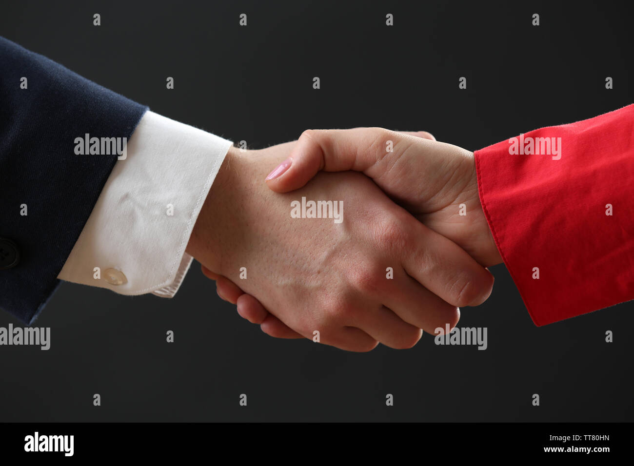 Business handshake on dark background Stock Photo - Alamy