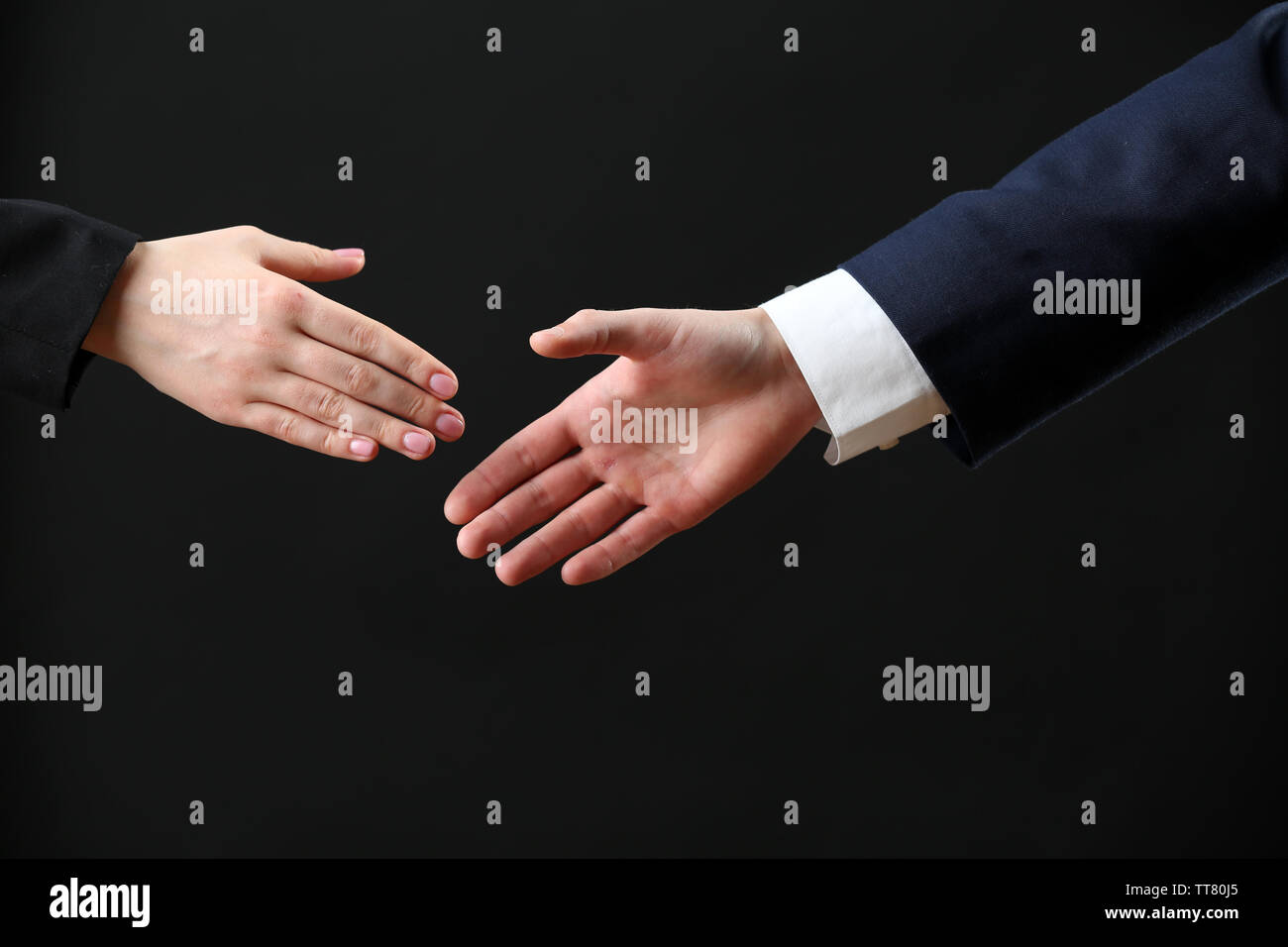 Business handshake on dark background Stock Photo - Alamy