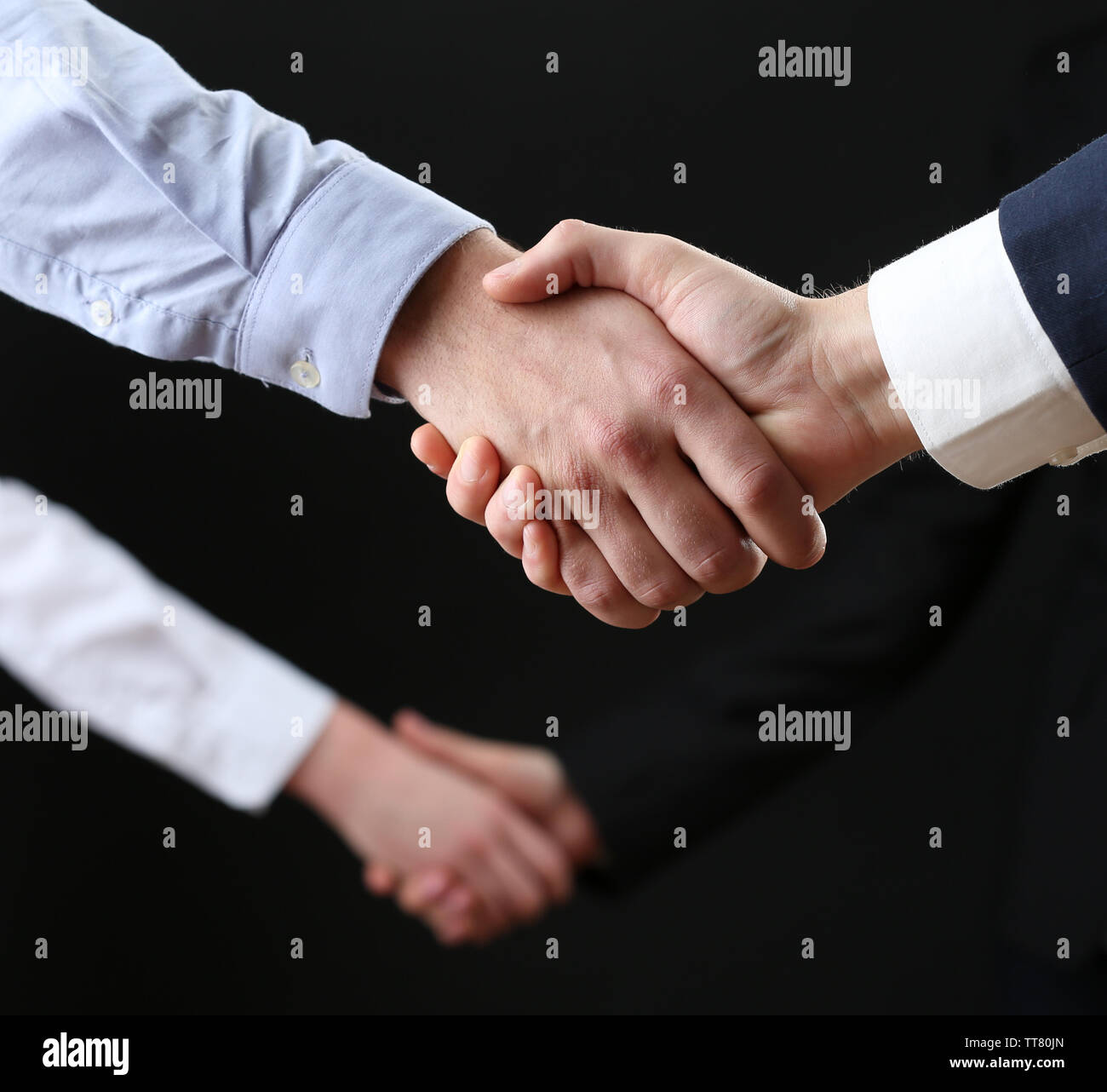 Business handshake on dark background Stock Photo - Alamy