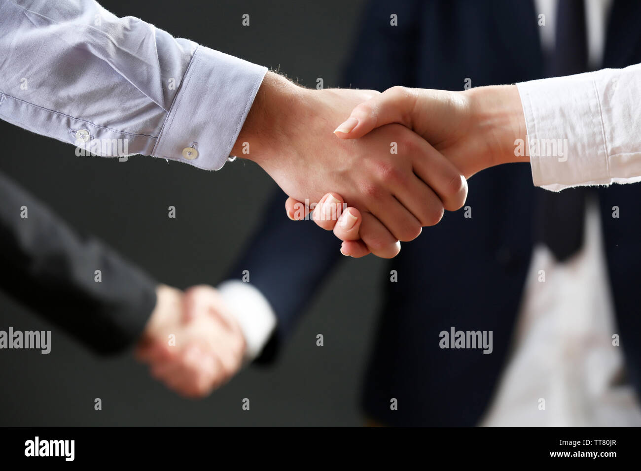 Business handshake on dark background Stock Photo - Alamy