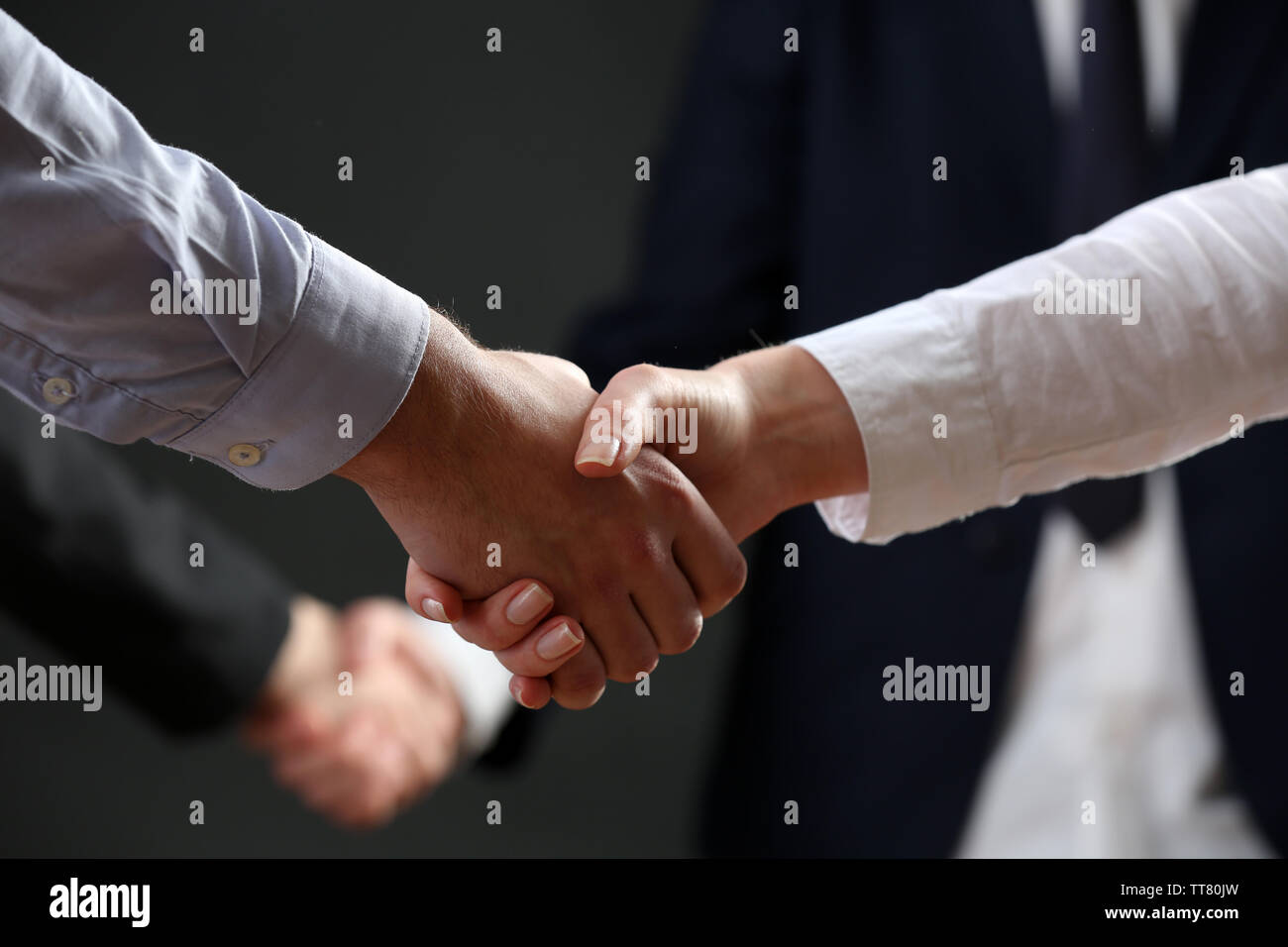 Business handshake on dark background Stock Photo - Alamy