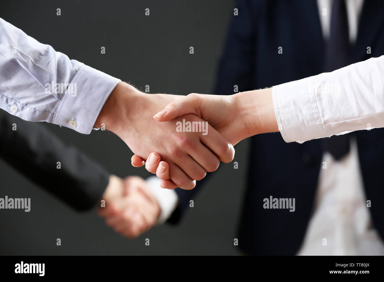 Business handshake on dark background Stock Photo - Alamy