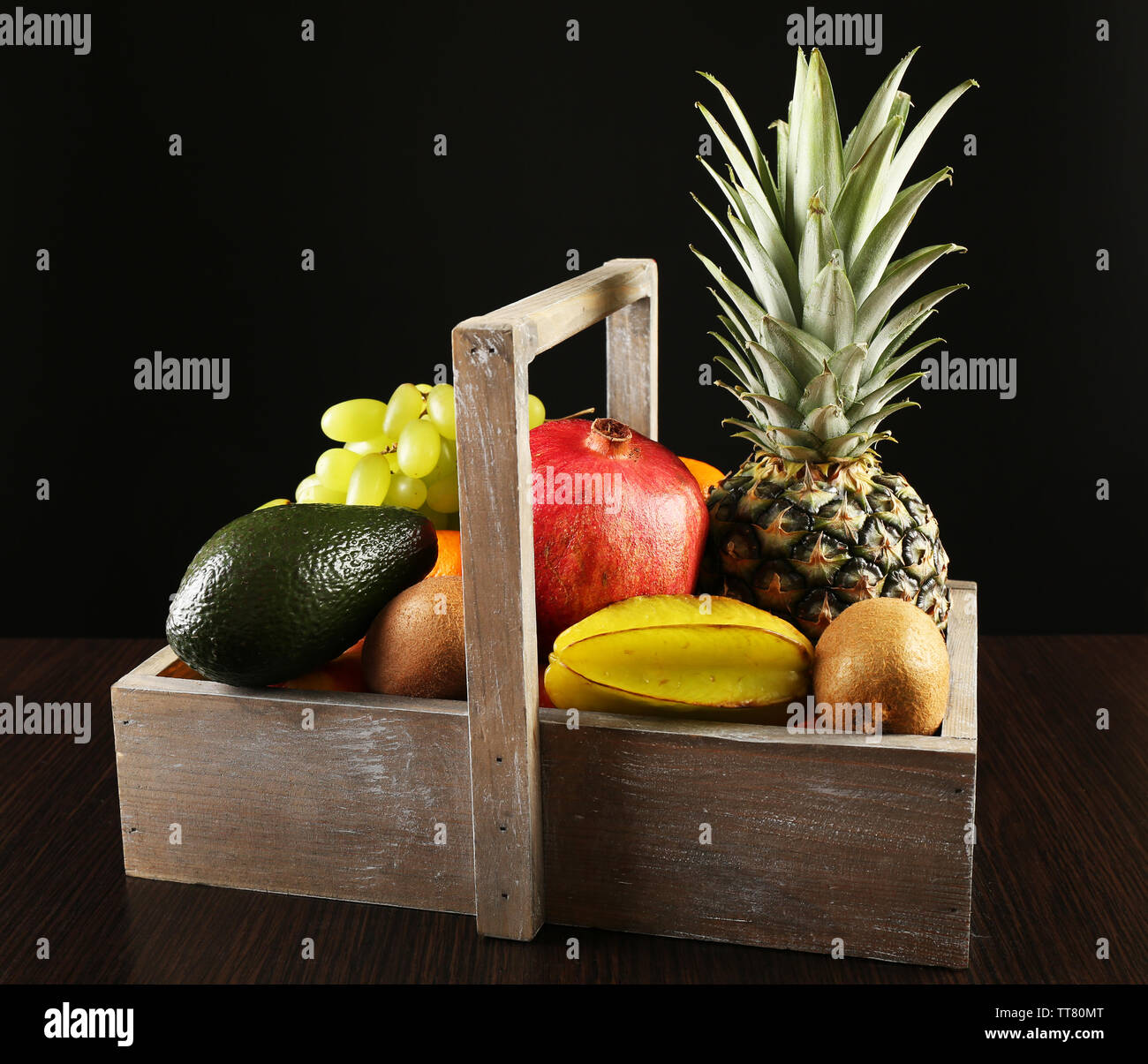 Assortment of fruits in box on dark background Stock Photo - Alamy