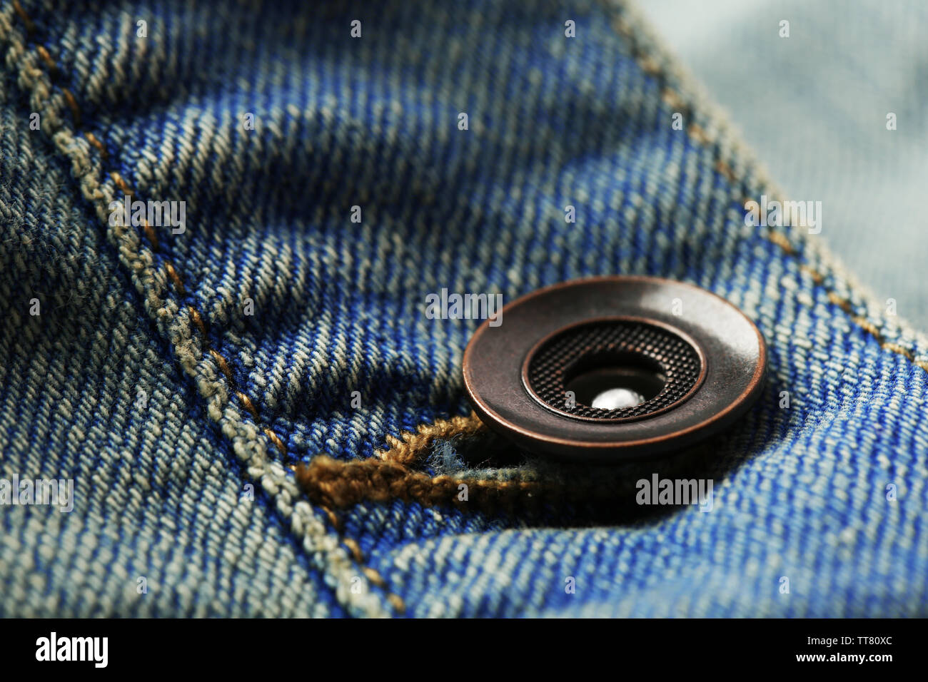Metal button on clothes close up Stock Photo - Alamy