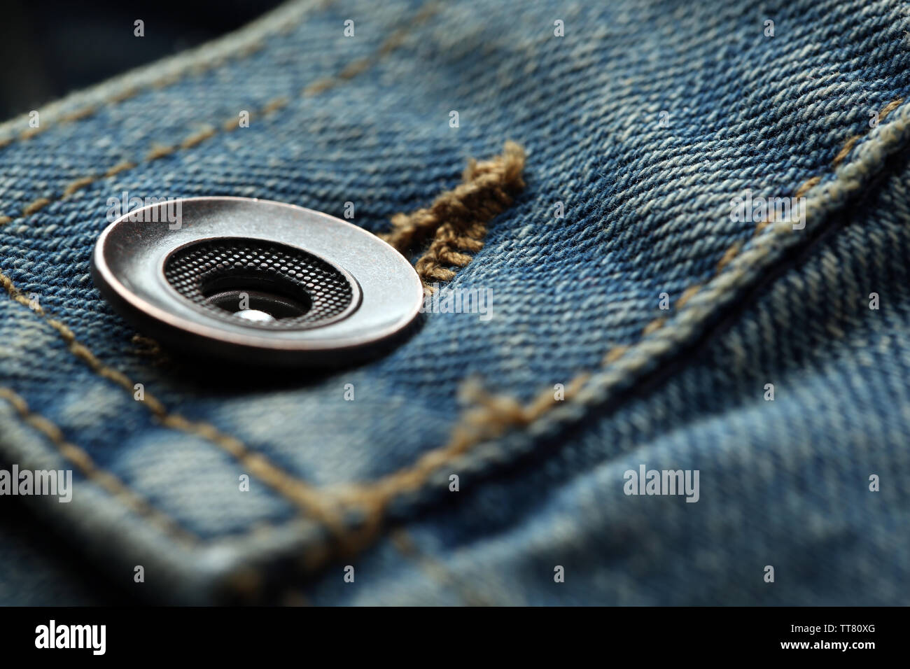 Metal button on clothes close up Stock Photo - Alamy
