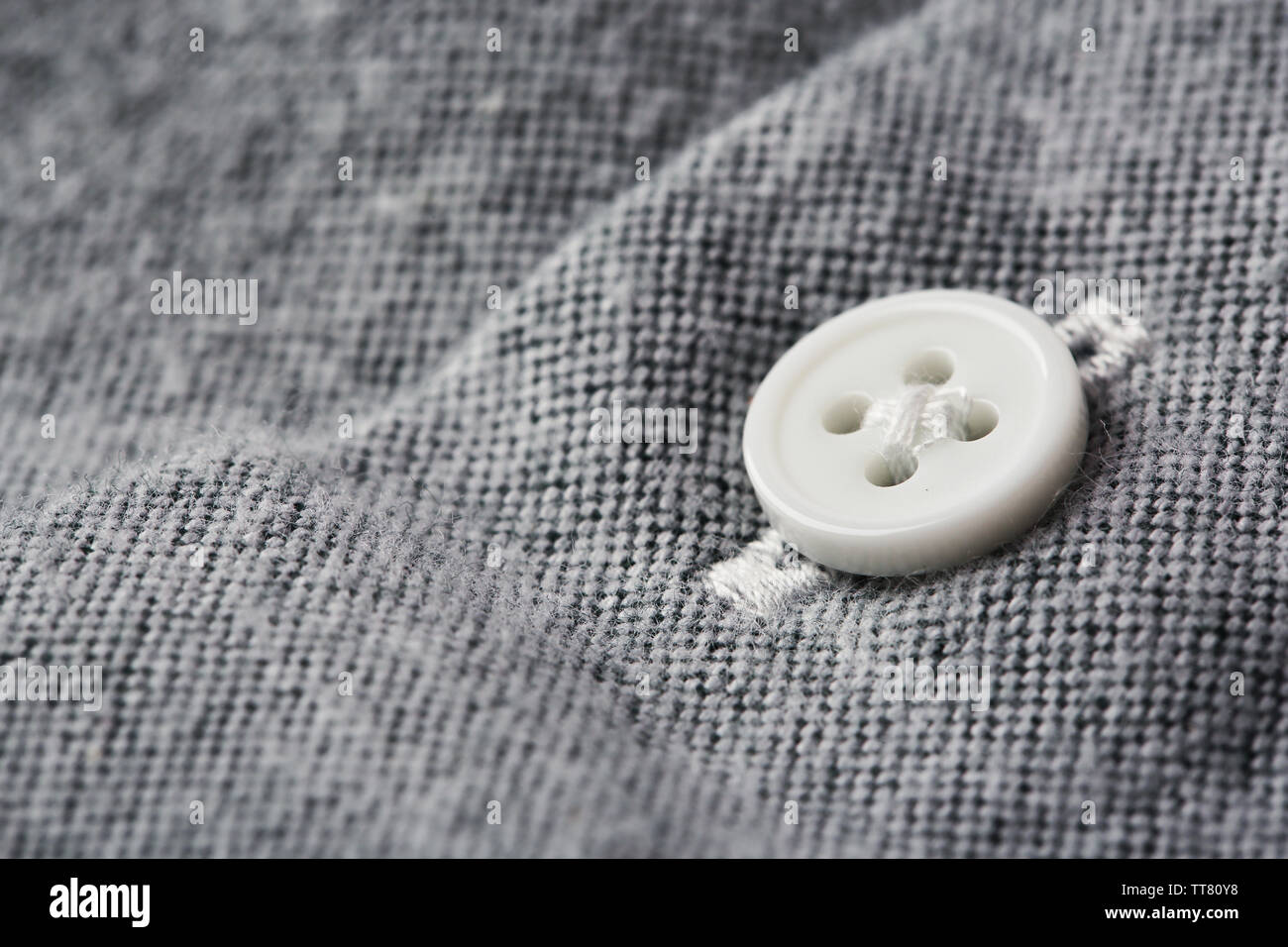 Button on clothes close up Stock Photo - Alamy