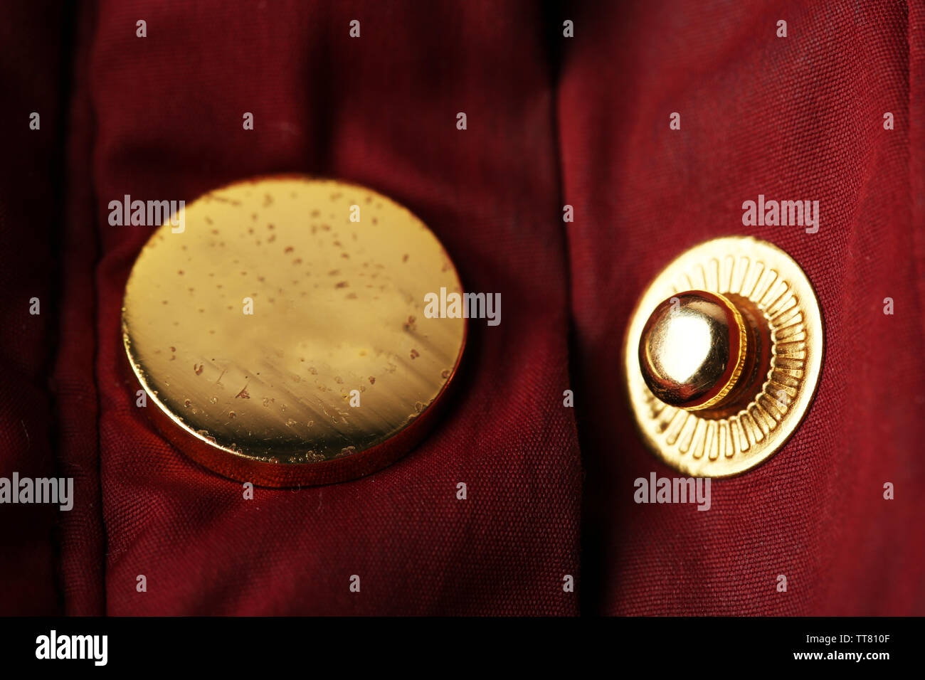 Metal button on clothes close up Stock Photo - Alamy