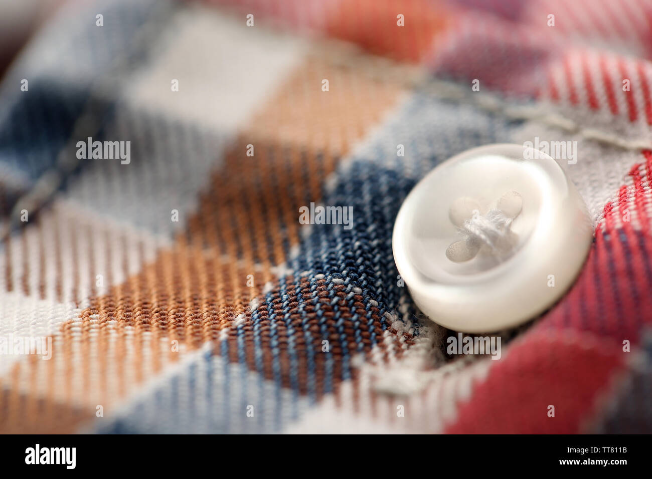 Button on clothes close up Stock Photo - Alamy