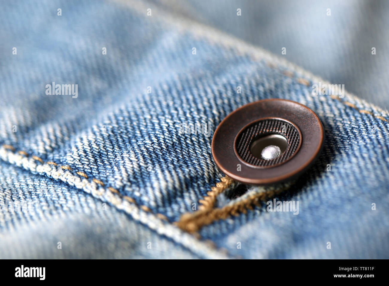 Metal button on clothes close up Stock Photo - Alamy